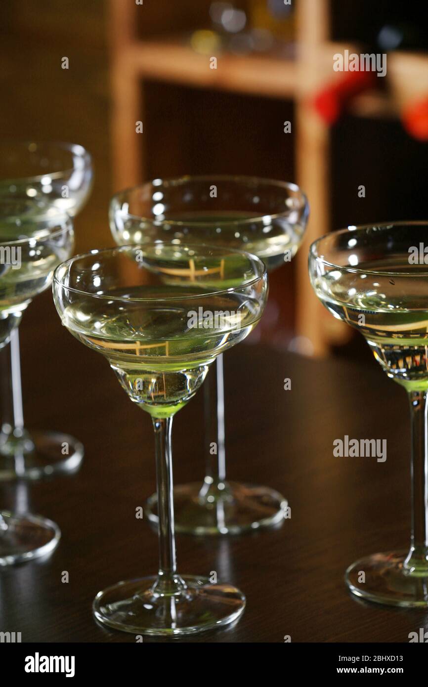 Glasses of cocktails on bar background Stock Photo - Alamy