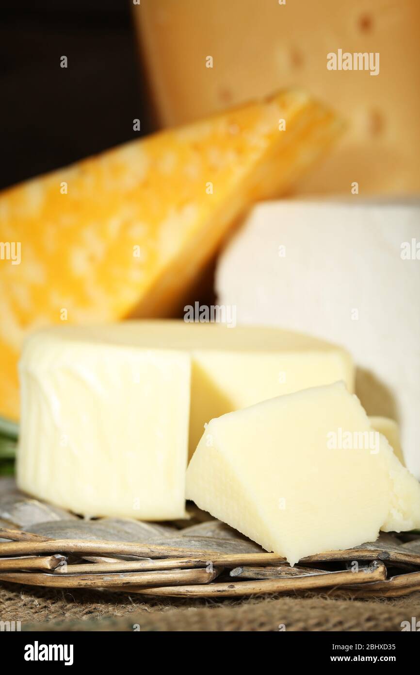 Different sort of cheese on wicker tray, closeup Stock Photo - Alamy