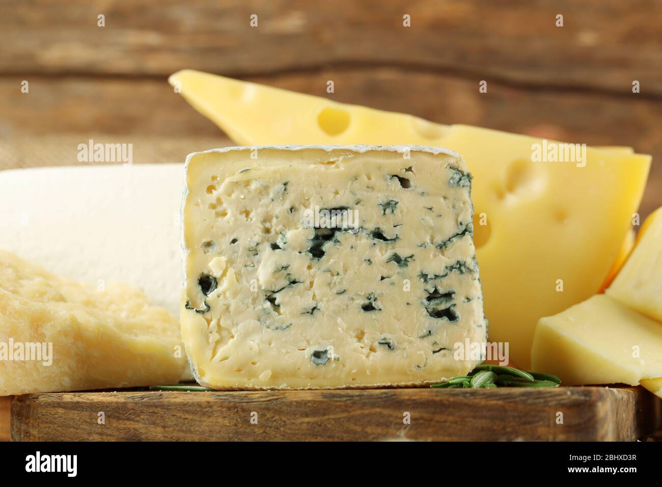 Different sort of cheese on wooden table, closeup Stock Photo - Alamy