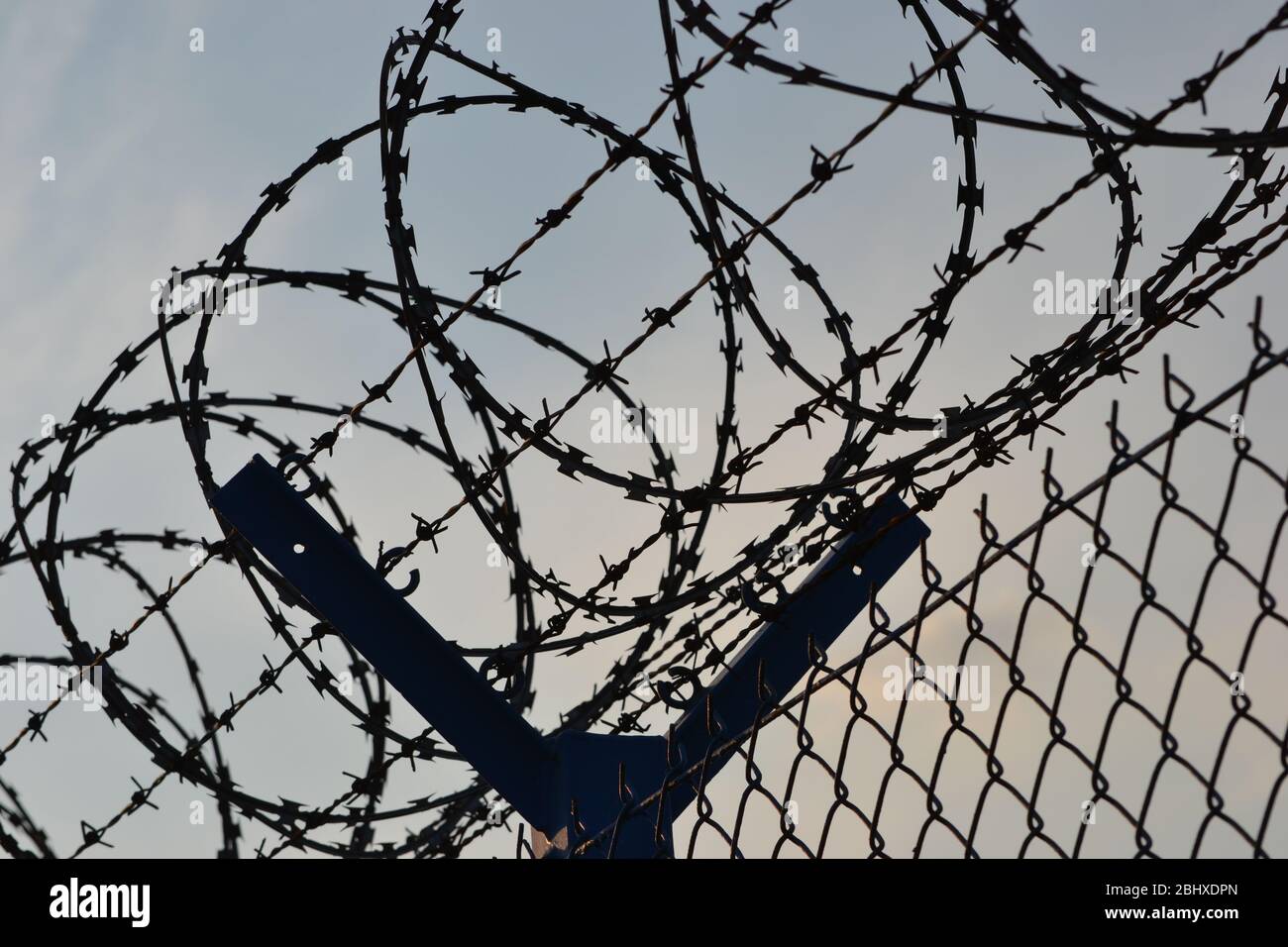 Prison gate with barbed wire hi-res stock photography and images - Alamy