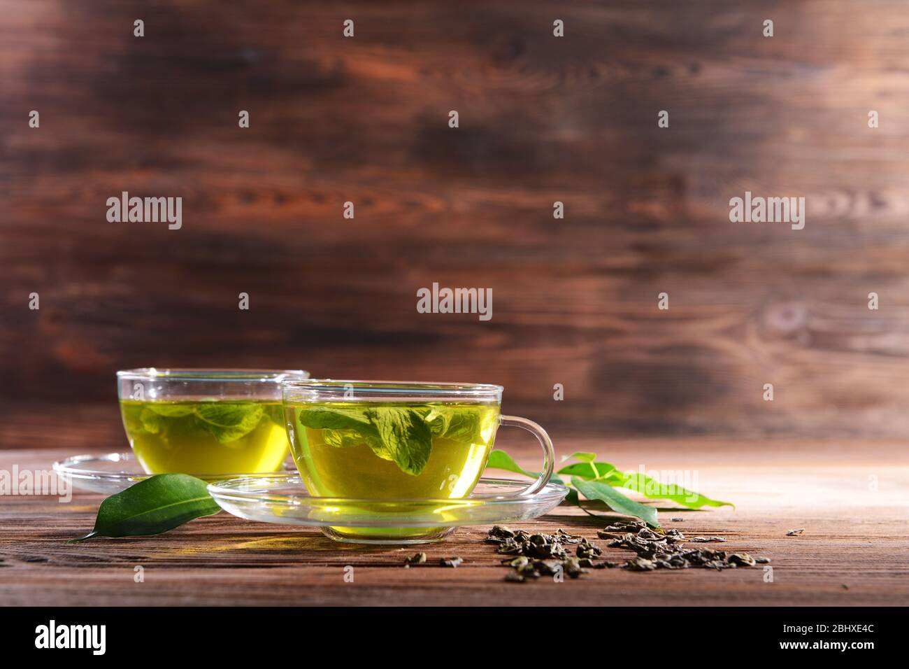 Cups of green tea on table on wooden background Stock Photo - Alamy