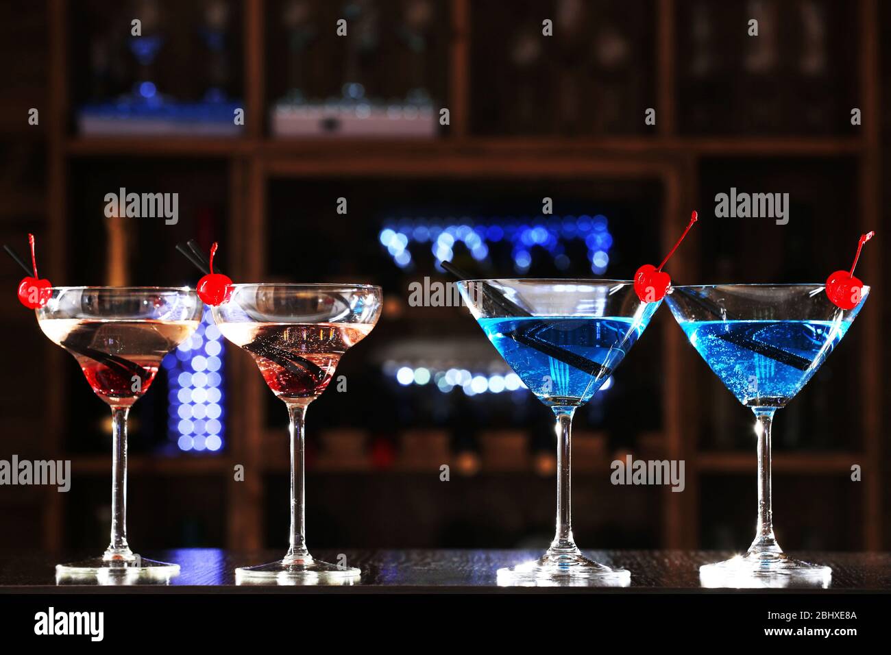 Glasses of cocktails on bar background Stock Photo - Alamy