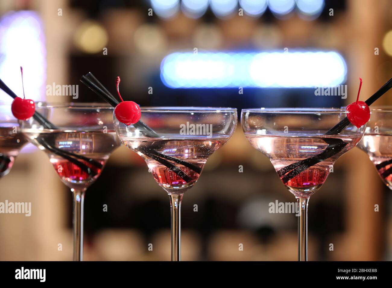 Glasses of cocktails on bar background Stock Photo - Alamy