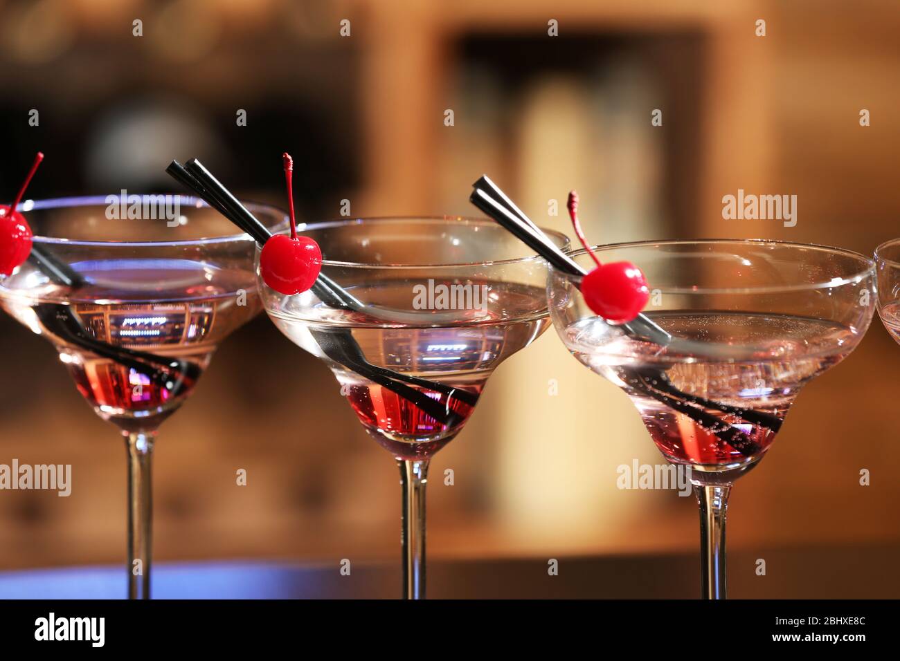 Glasses of cocktails on bar background Stock Photo - Alamy