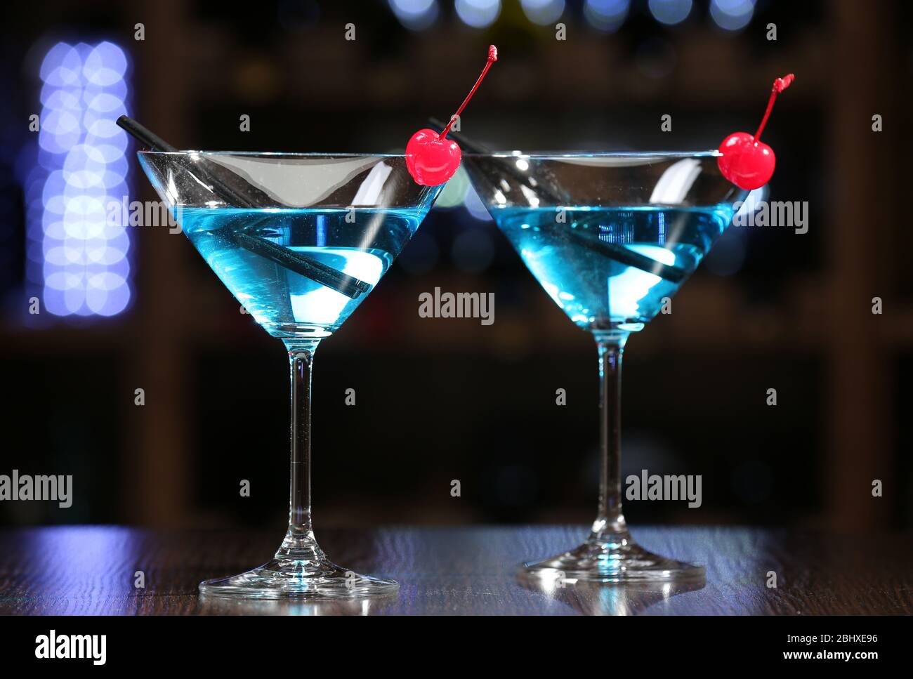 Glasses of cocktails on bar background Stock Photo - Alamy