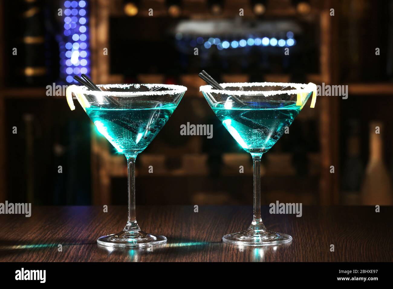 Glasses of cocktails on bar background Stock Photo - Alamy
