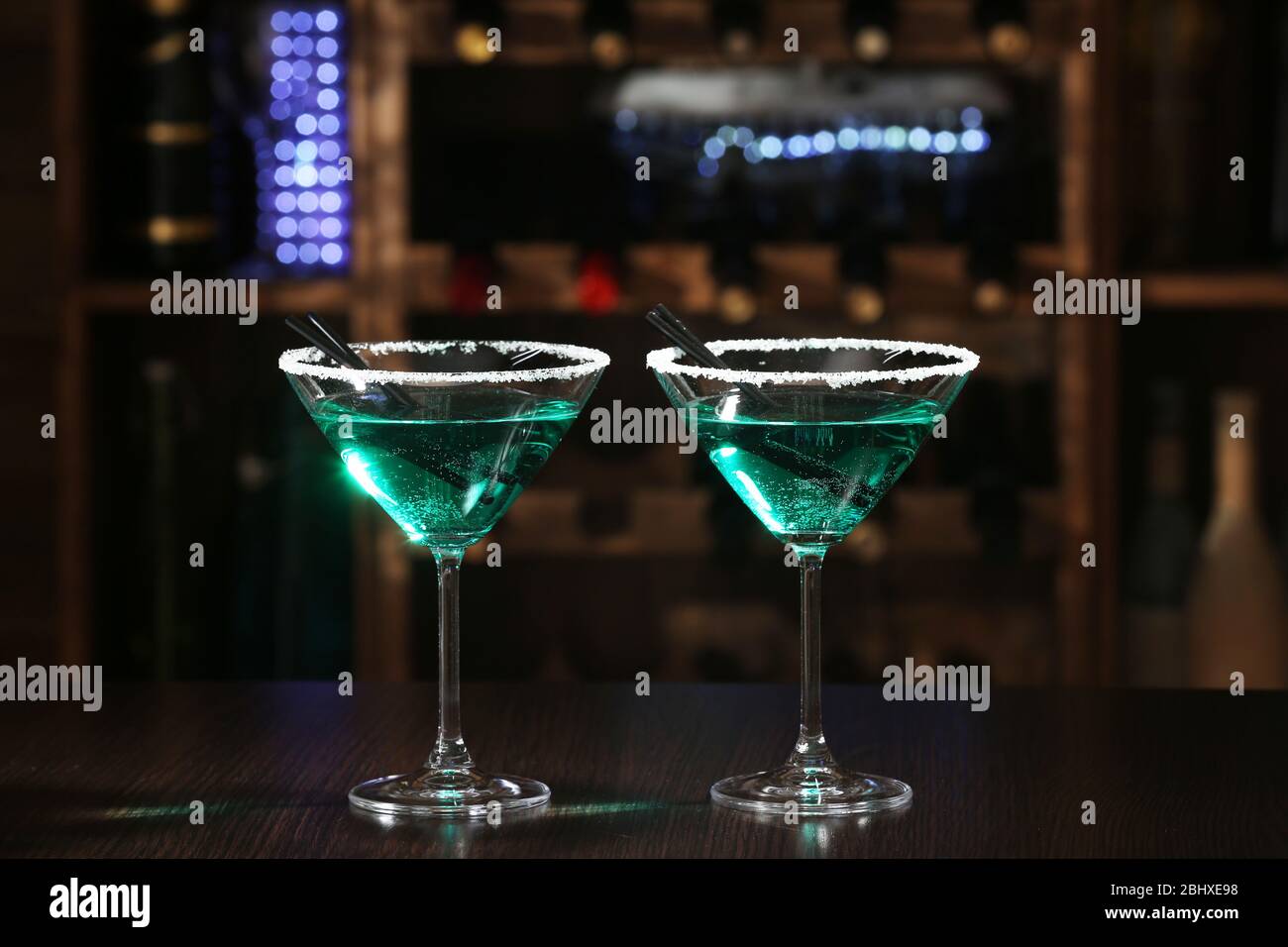 Glasses of cocktails on bar background Stock Photo - Alamy