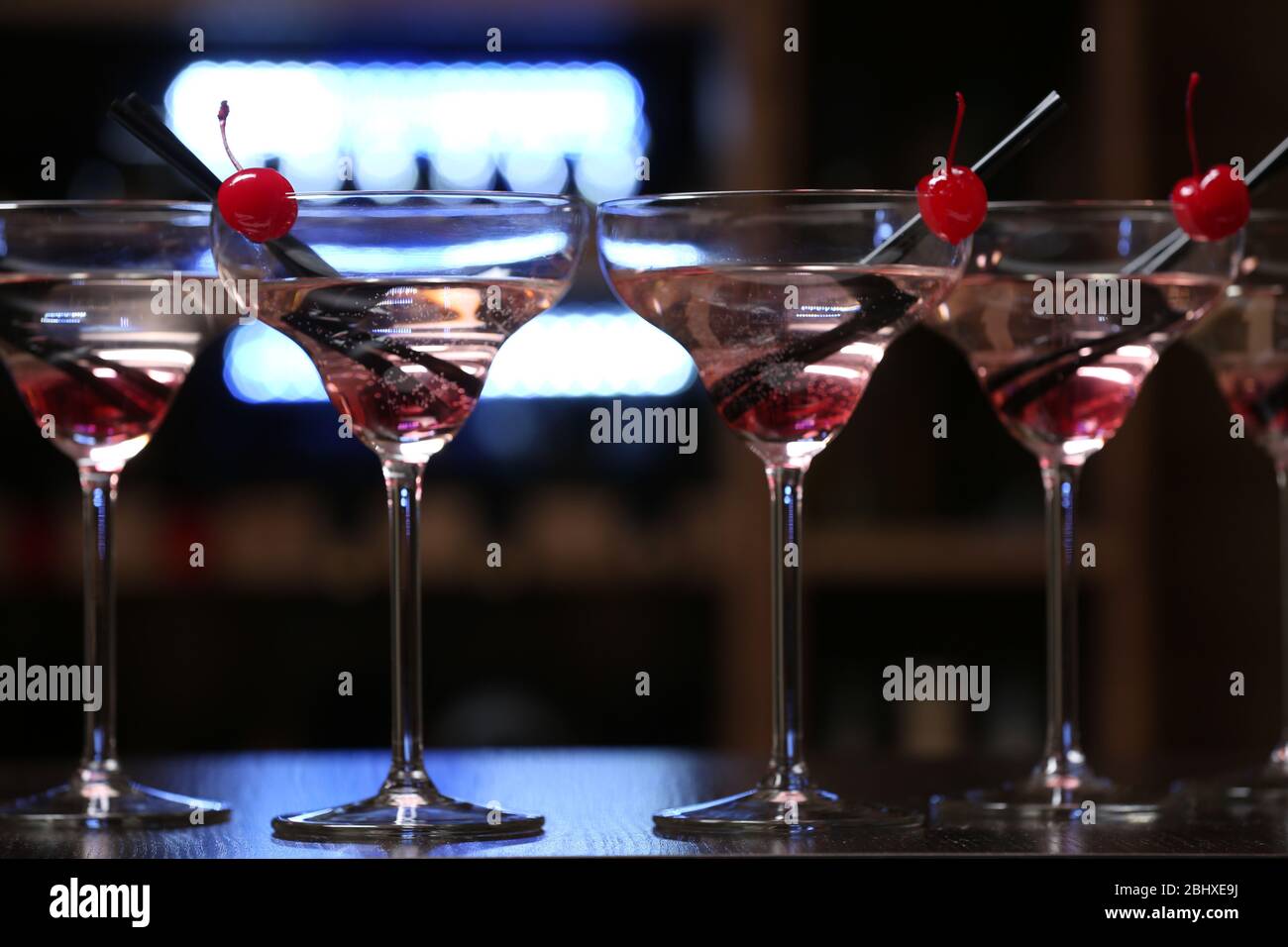 Glasses of cocktails on bar background Stock Photo - Alamy