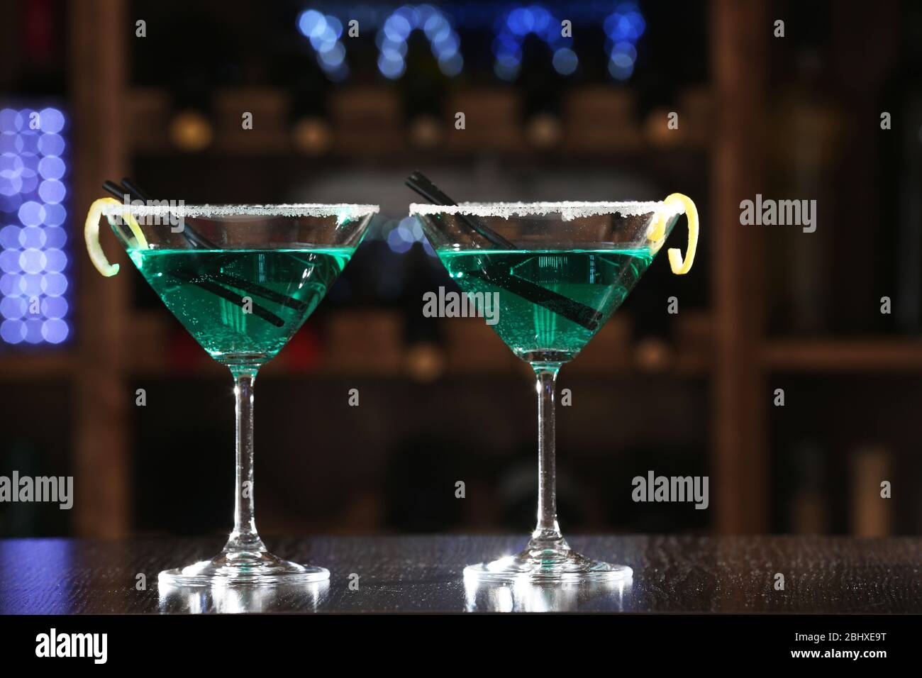 Glasses of cocktails on bar background Stock Photo - Alamy