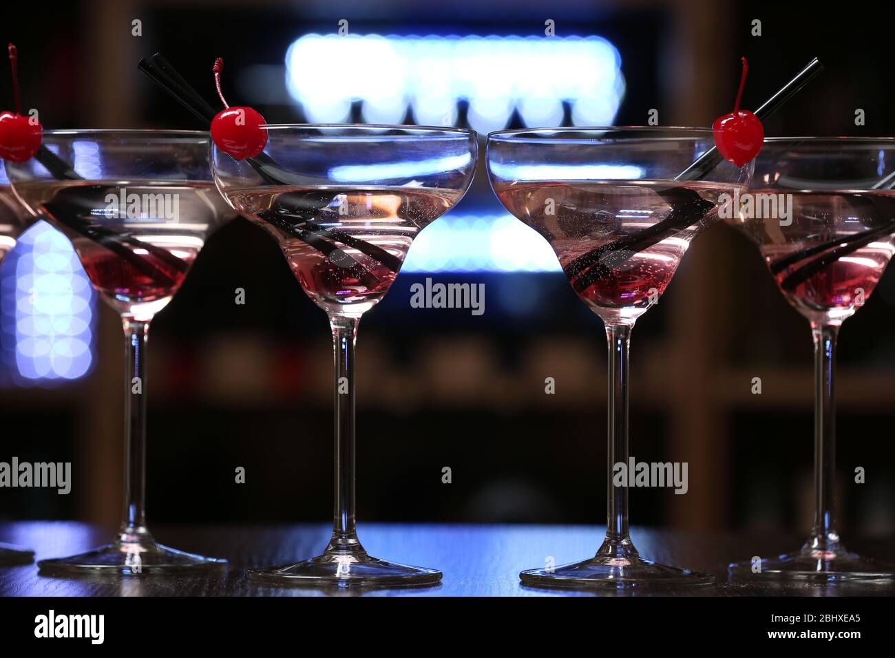 Glasses of cocktails on bar background Stock Photo - Alamy