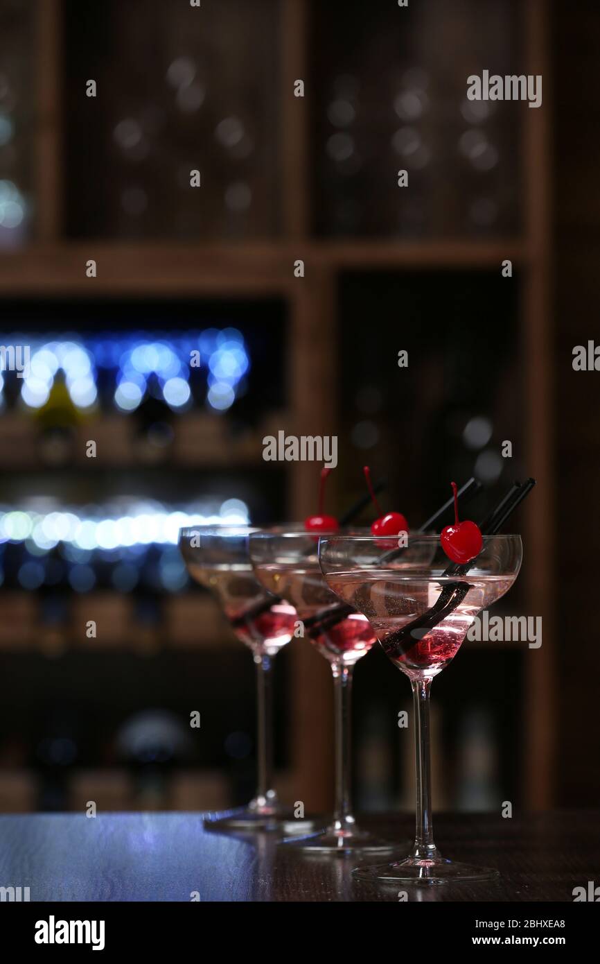 Glasses of cocktails on bar background Stock Photo - Alamy