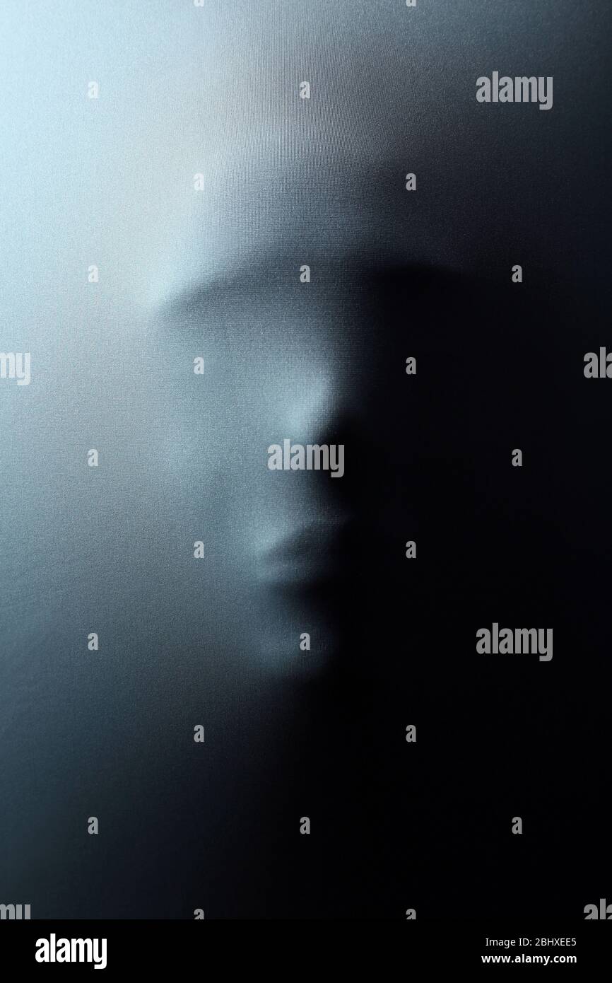 Human face pressing through fabric as horror background Stock Photo - Alamy