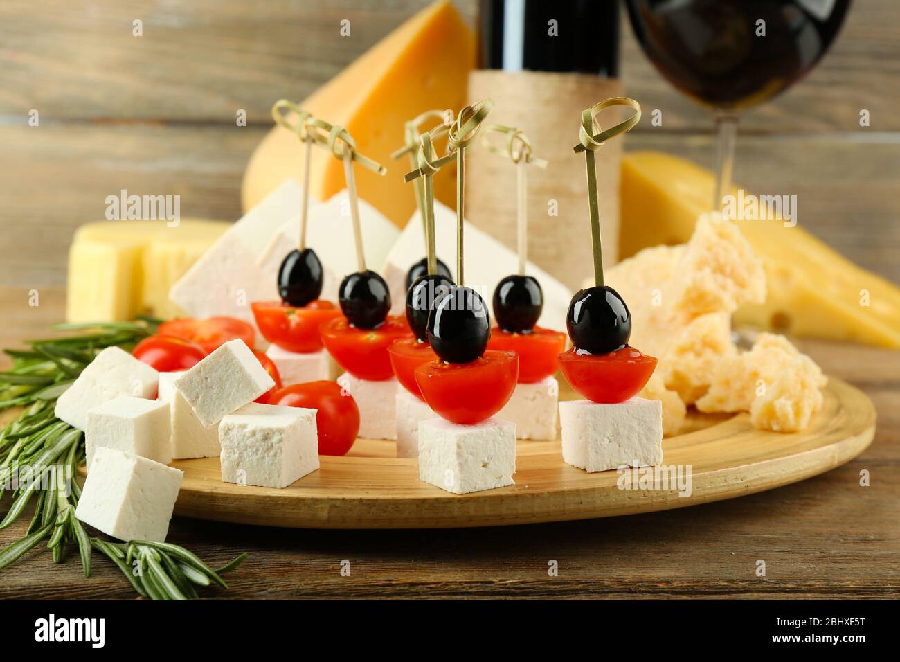 Cheese canapes with wine on table close up Stock Photo - Alamy