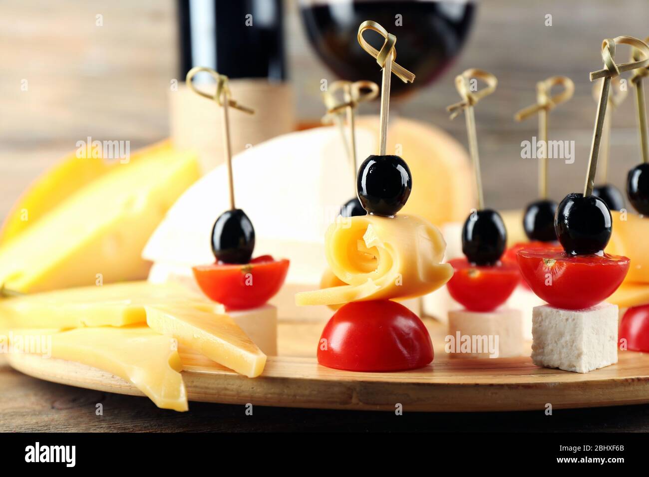 Cheese canapes with wine on table close up Stock Photo - Alamy