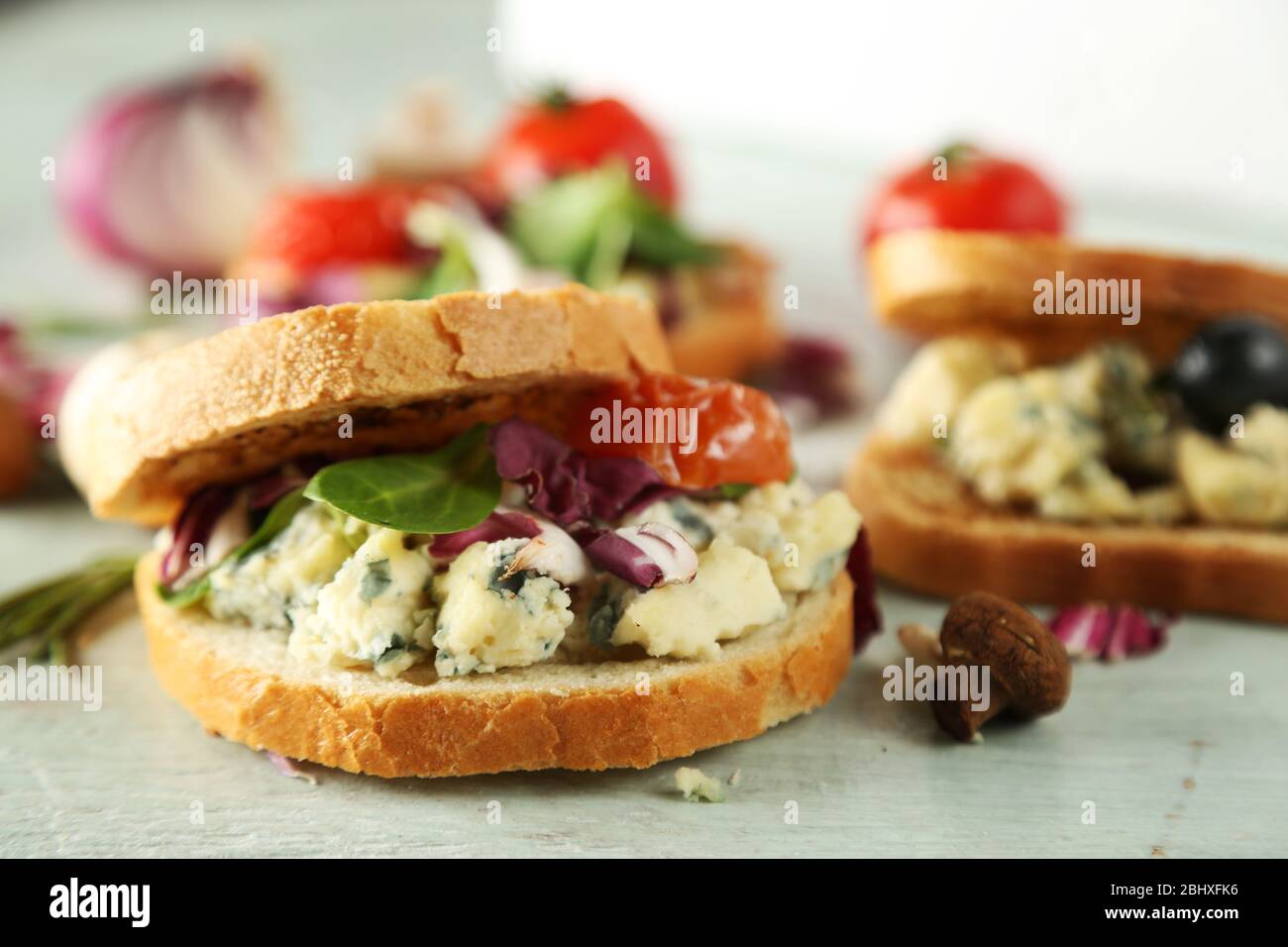Tasty sandwiches on wooden table, close up Stock Photo - Alamy