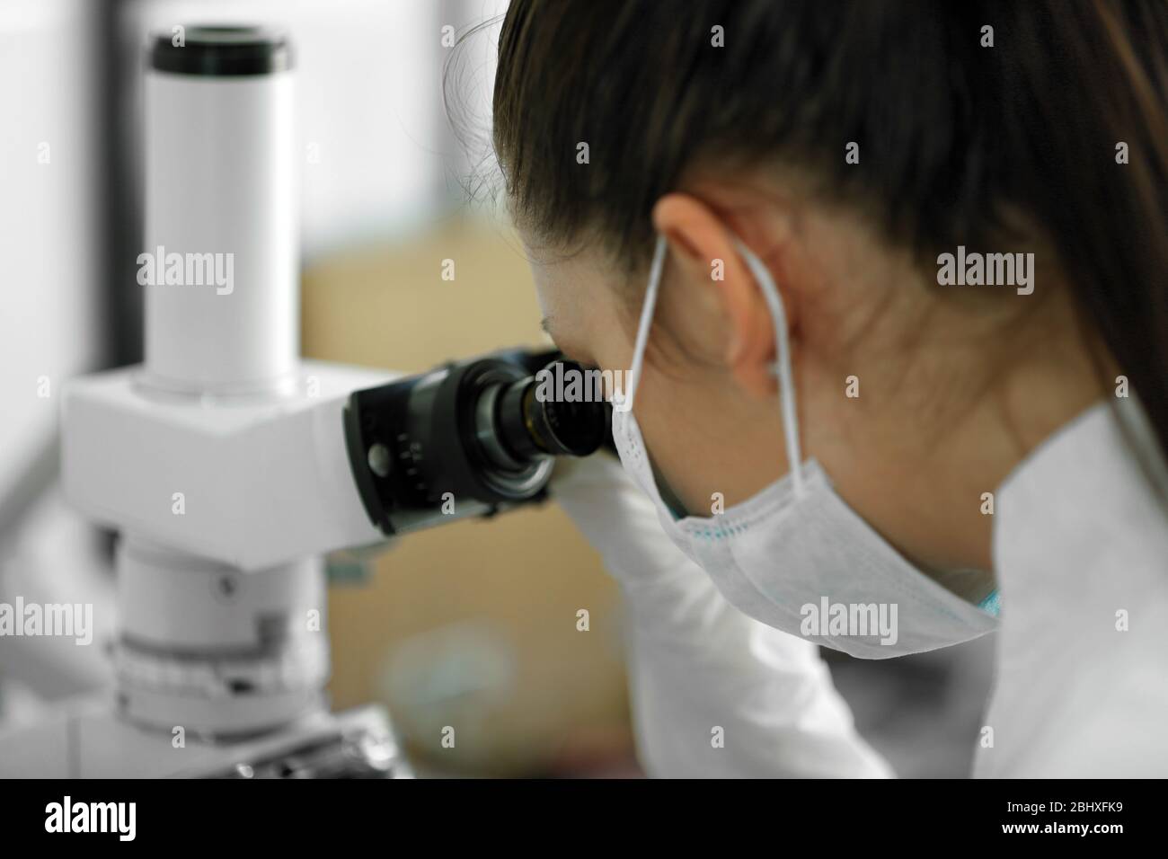 Female scientist looking through a microscope in laboratory Stock Photo ...