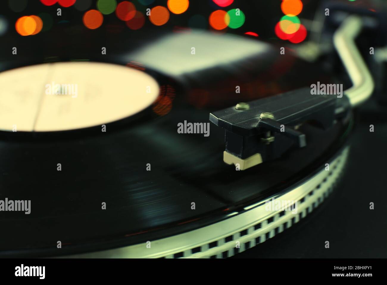 Gramophone with a vinyl record on colorful blurred background Stock ...
