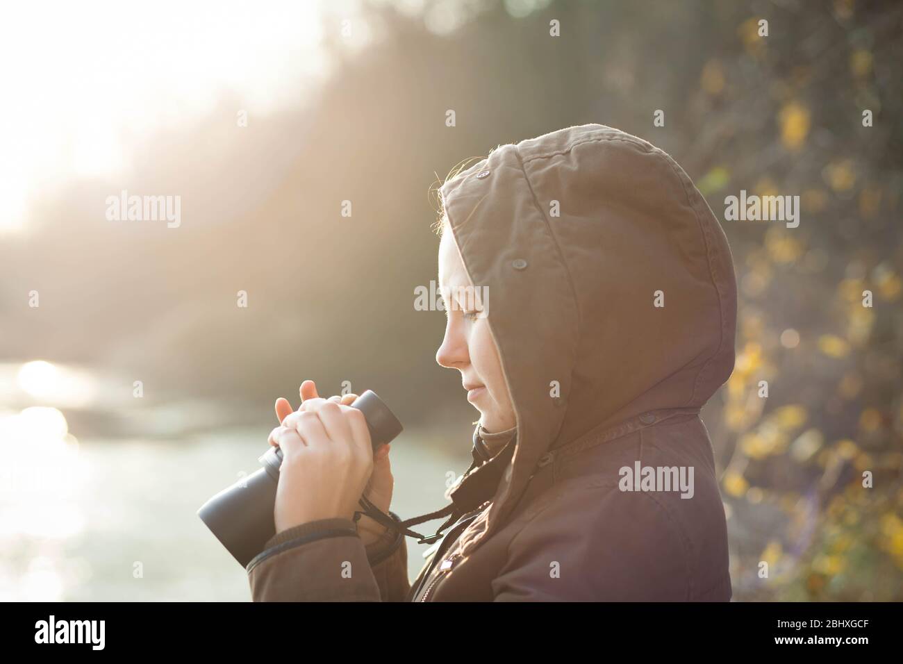 Young brunette woman looking after the animals by professional ...