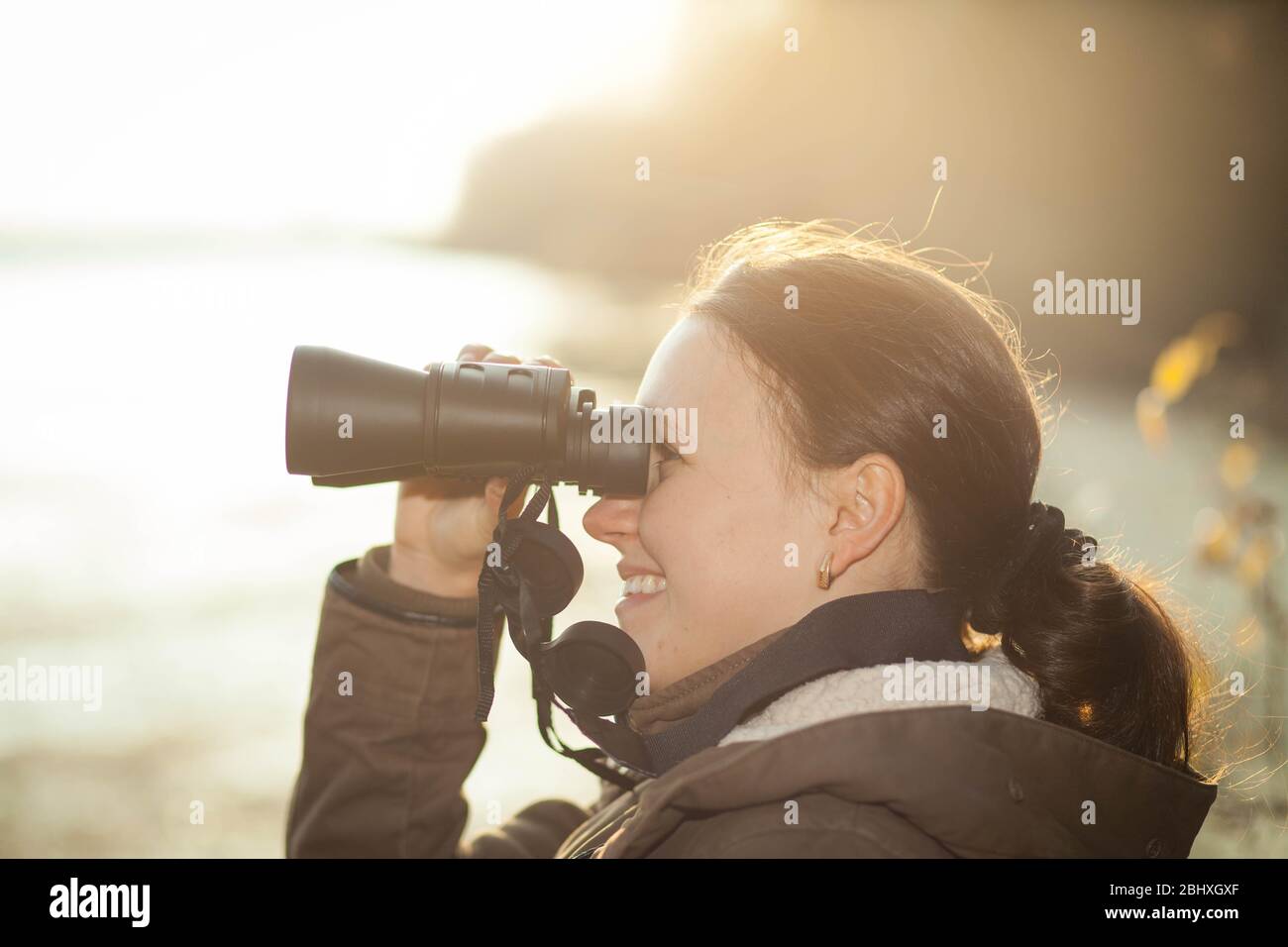 Young brunette woman looking after the animals by professional ...