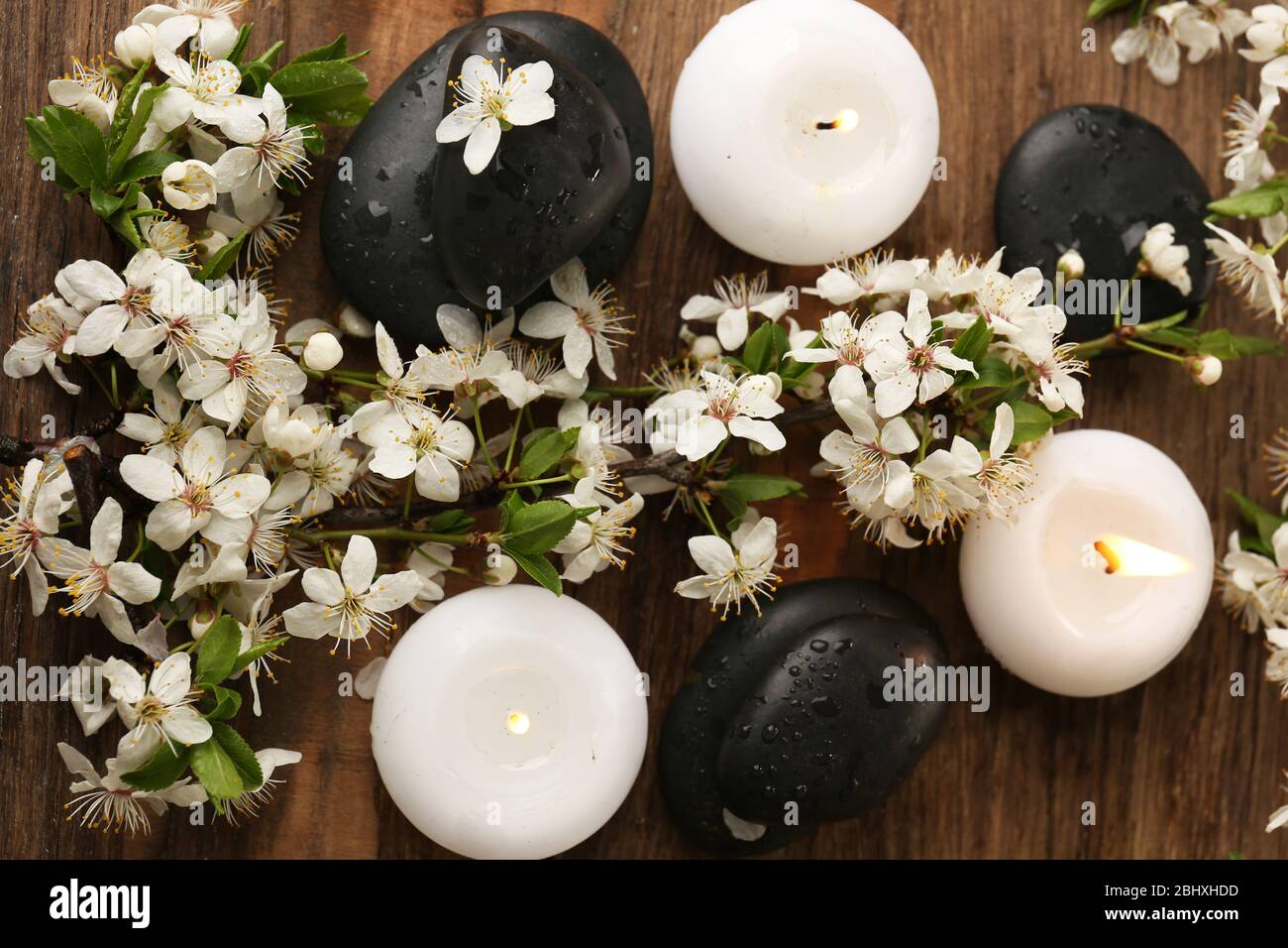 Spa stones with candles and spring flowers on table close up Stock ...