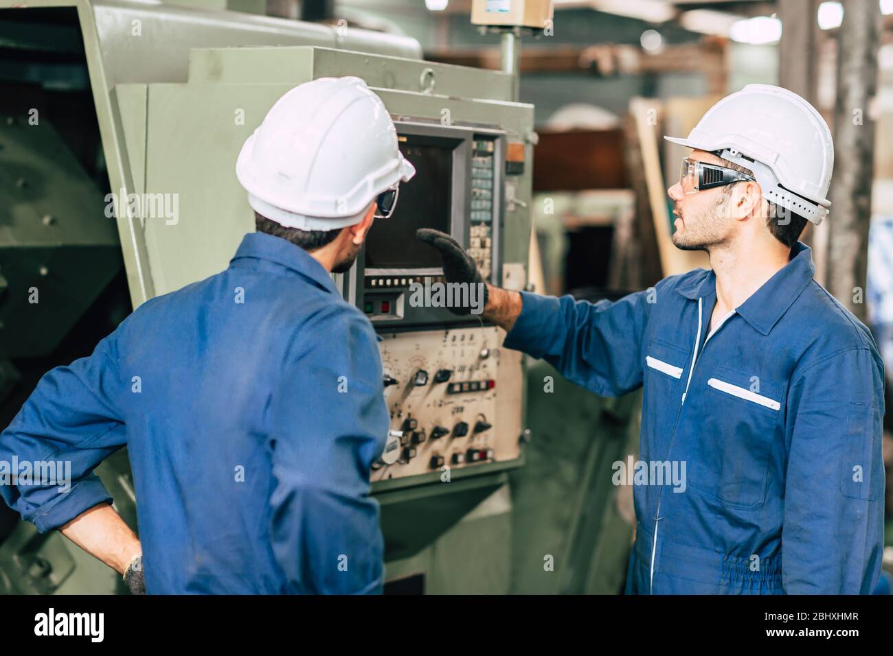 industry engineer team worker operate control heavy machine with ...