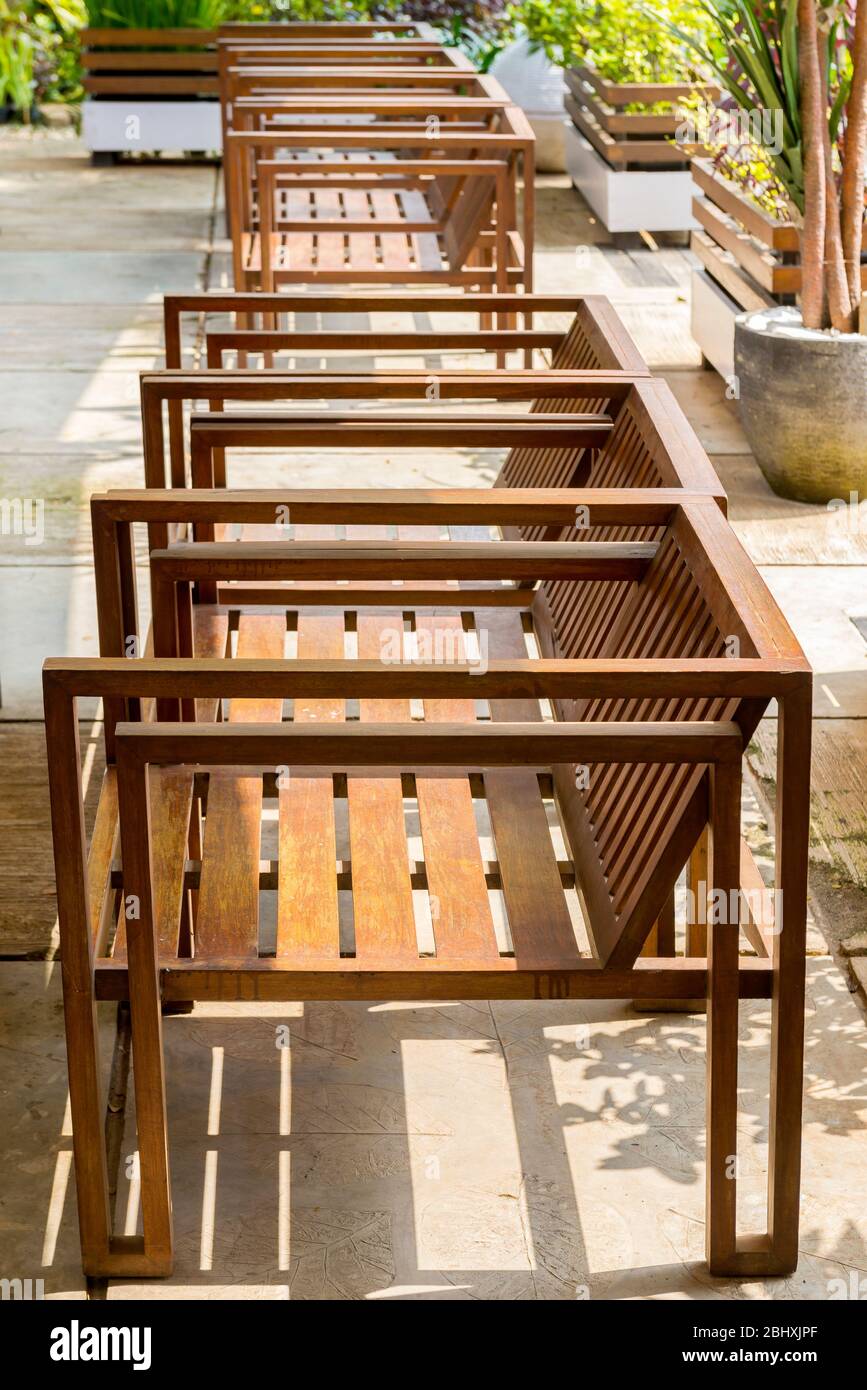 Close up view of a row of wooden chair on the floor Stock Photo - Alamy