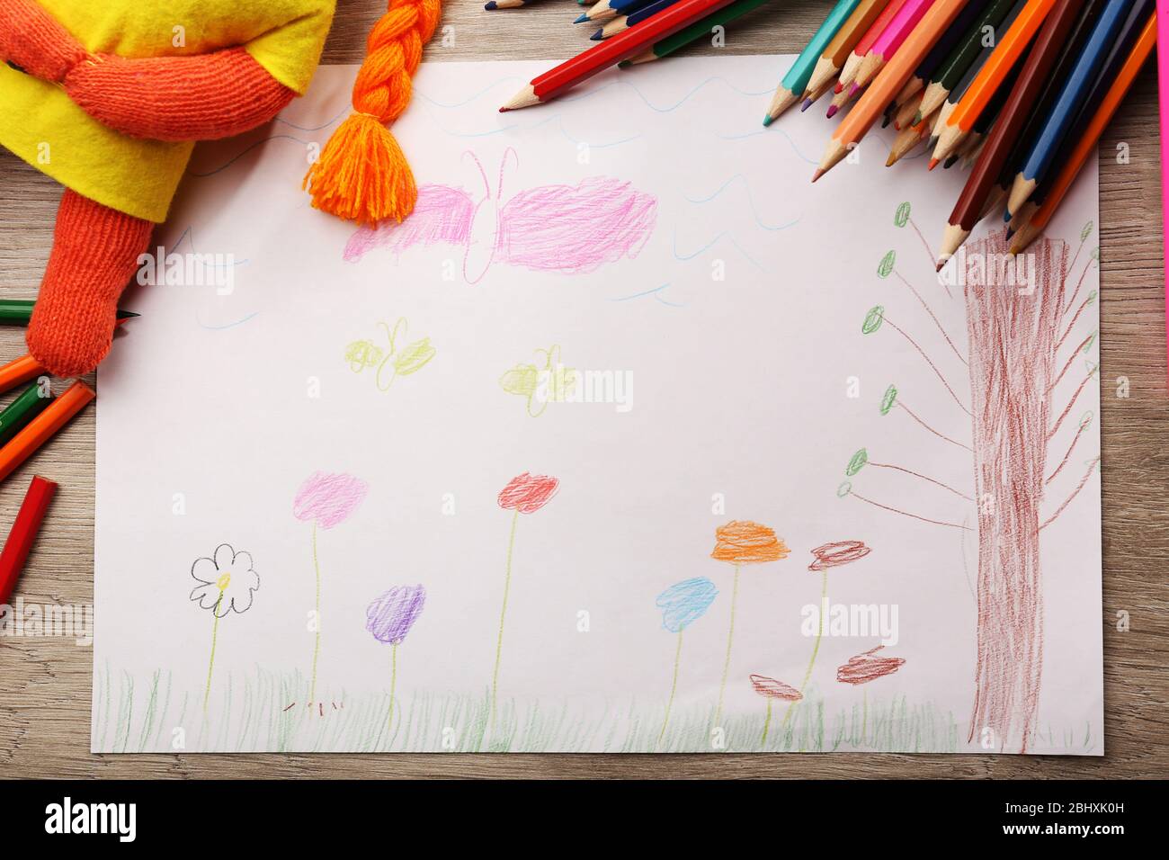 Kids drawing on white sheet of paper with crayons, closeup Stock Photo ...