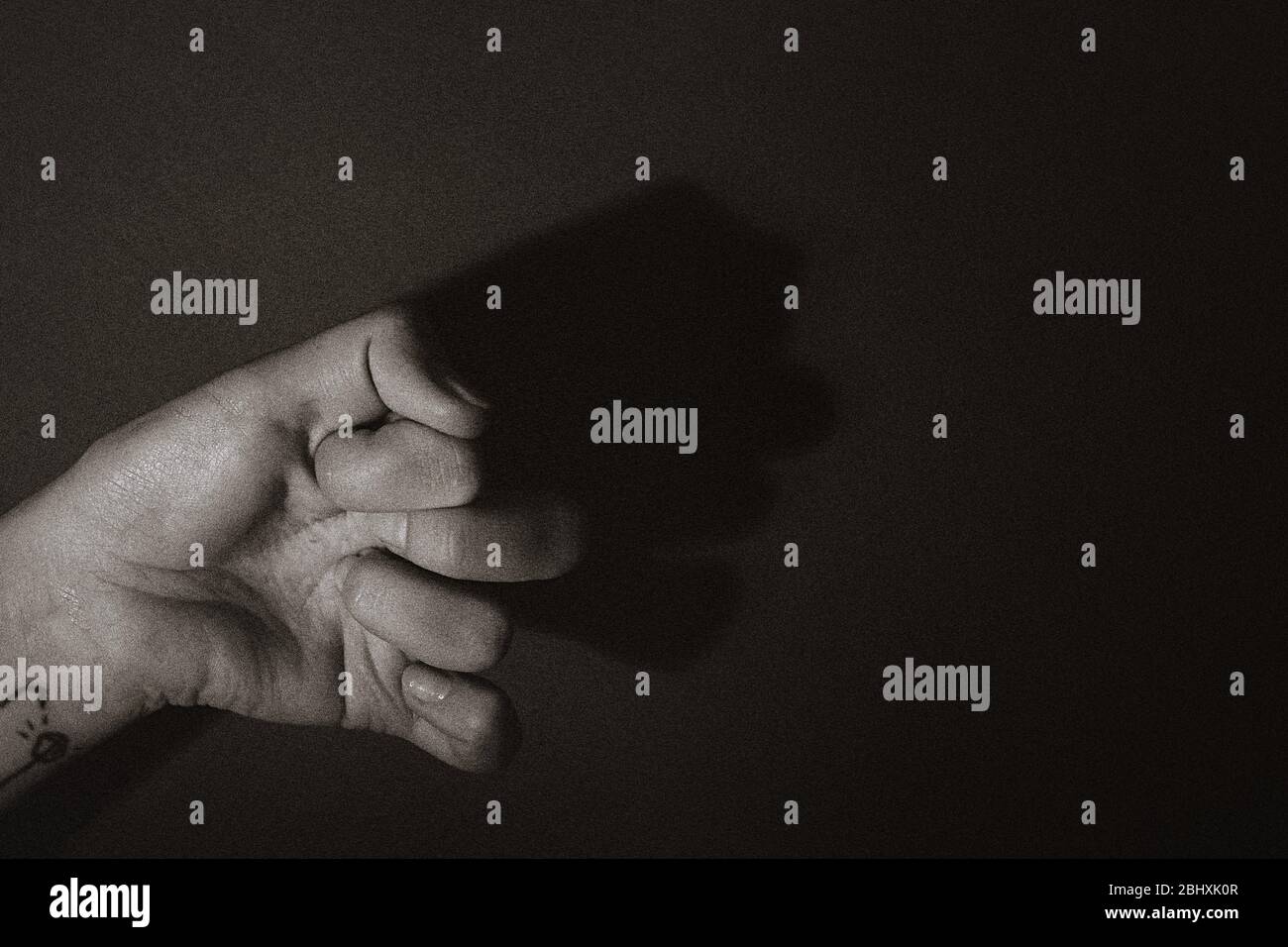 Shadow of female hand forming human face on dark background Stock Photo ...