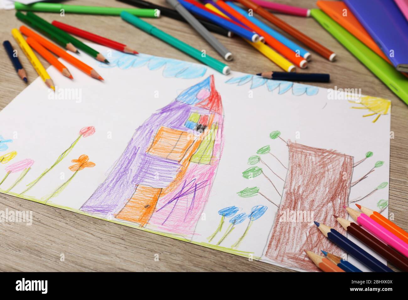 Kids drawing on white sheet of paper with crayons, closeup Stock Photo ...