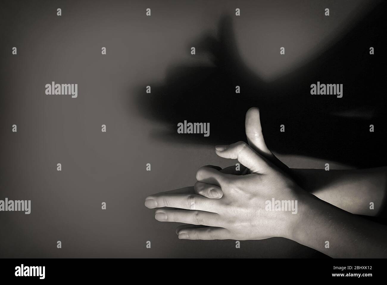 Hands gesture like dog face on gray background Stock Photo - Alamy