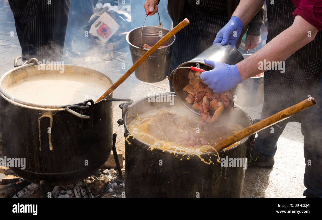 Preparation of food in bowlers on bonfire, cooking outdoor in a ...