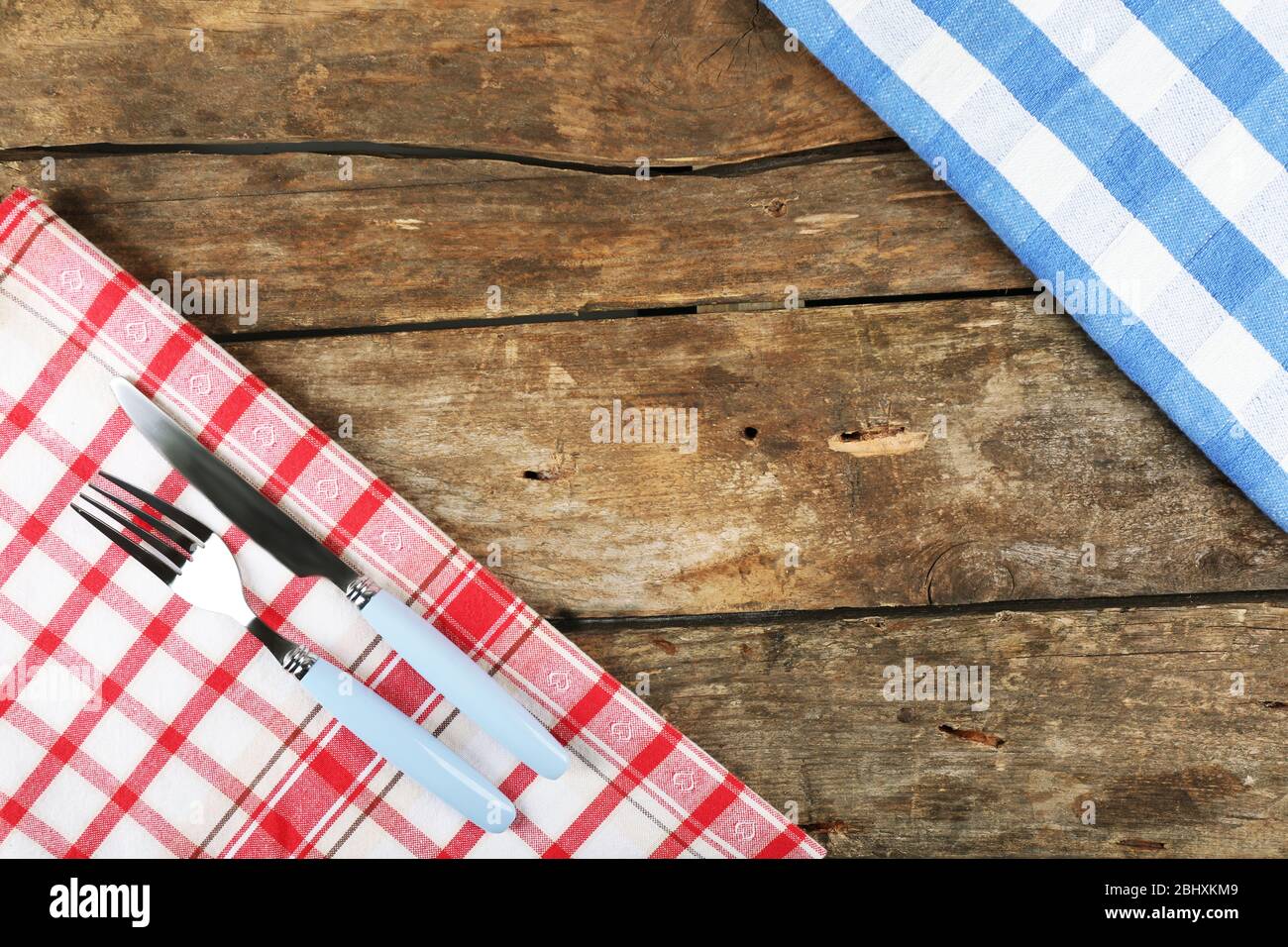 Checkered napkin with fork and knife on wooden table background Stock ...