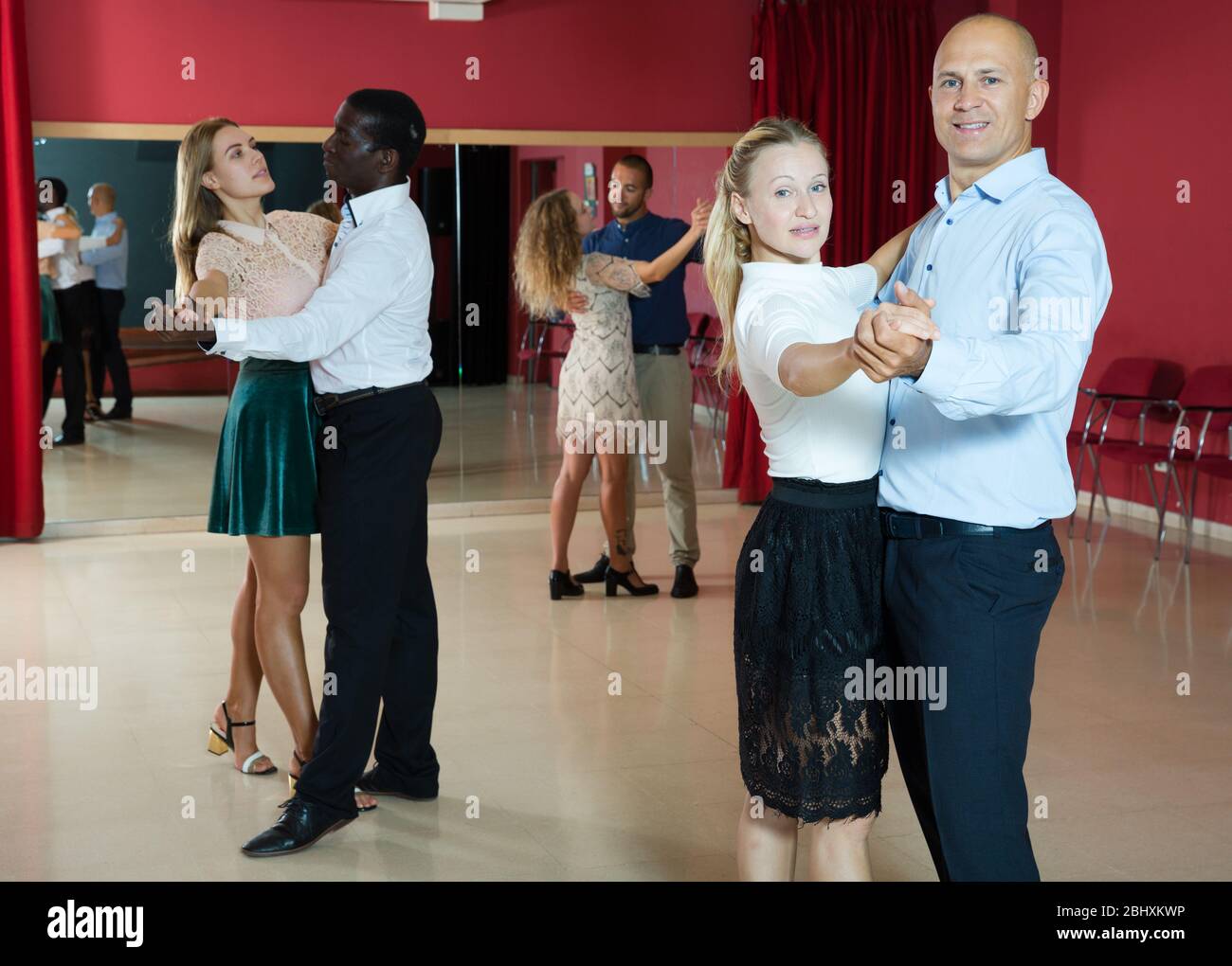 Couples of young people learning to technique of classical dance in ...