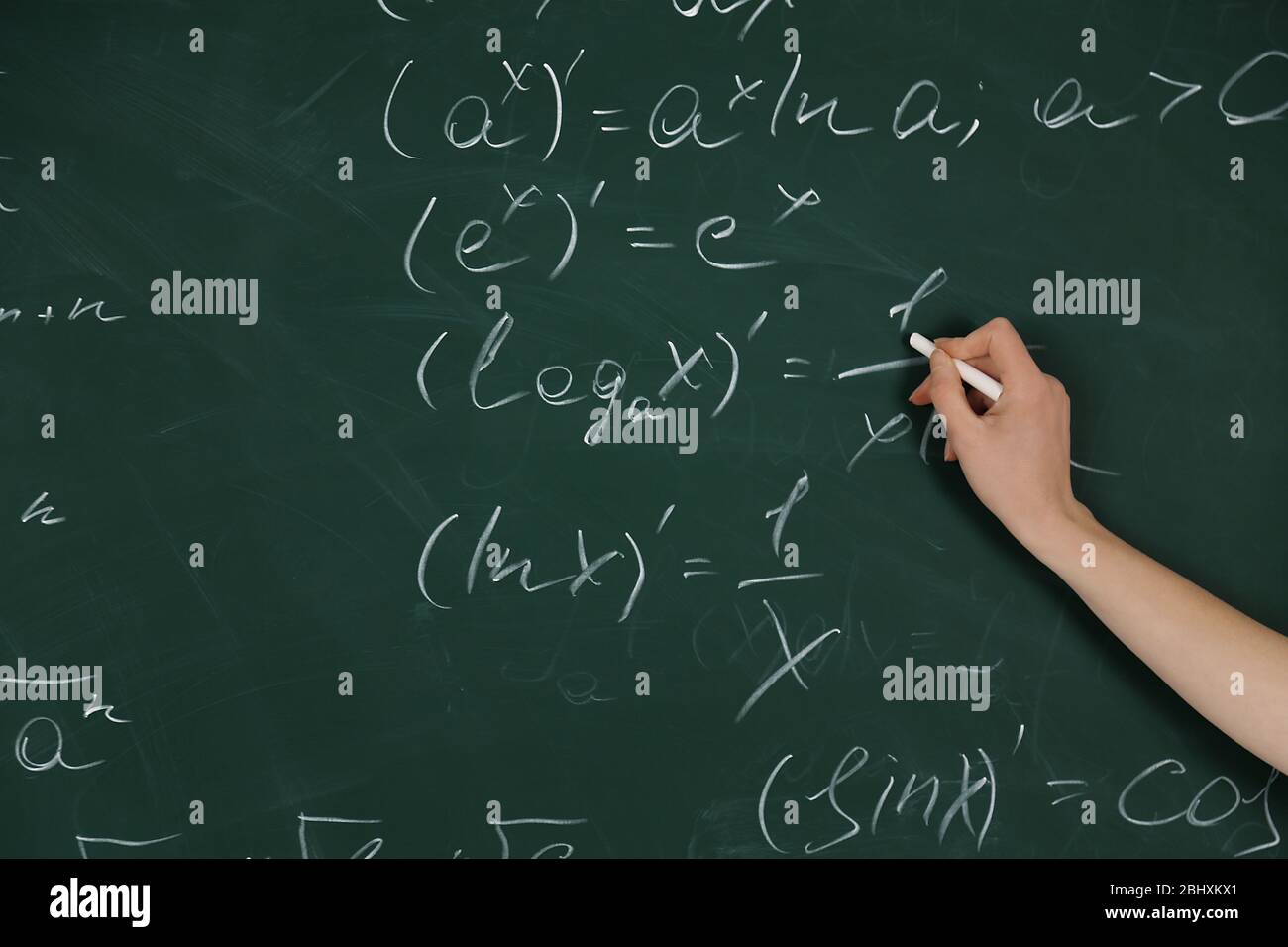 Female hand writing formulas on blackboard with chalk, close up Stock ...