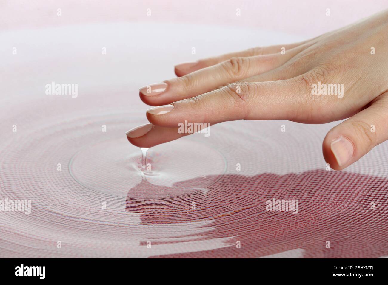 Finger touches water close up Stock Photo - Alamy