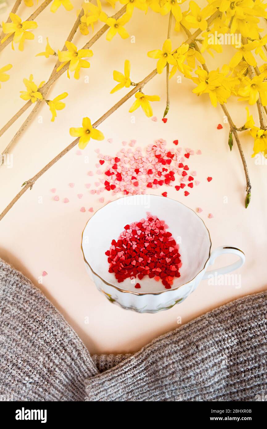 spring tea party. small white cup filled with pink and red spangles ...