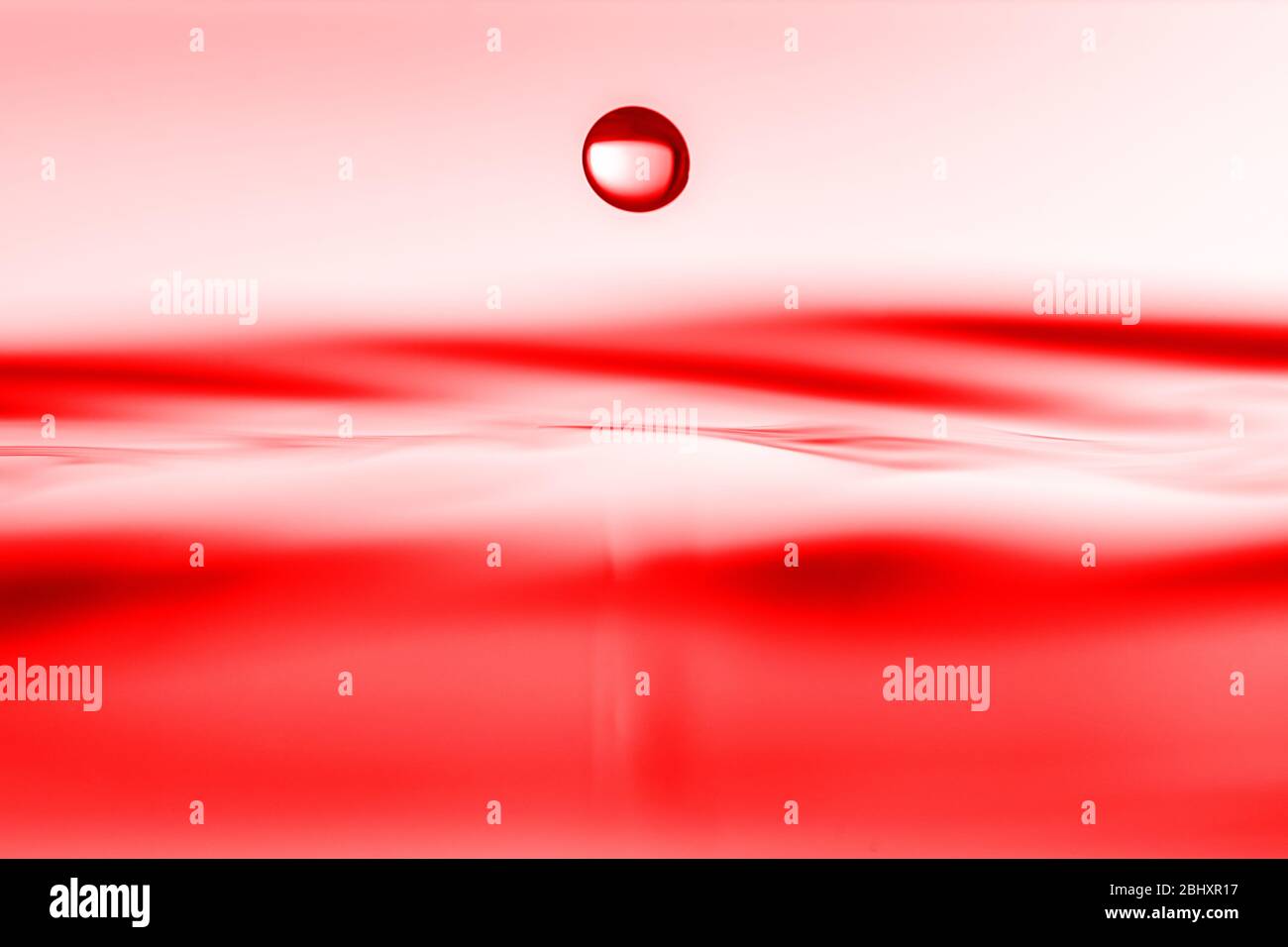 A water drop falling down onto a water surface Stock Photo - Alamy