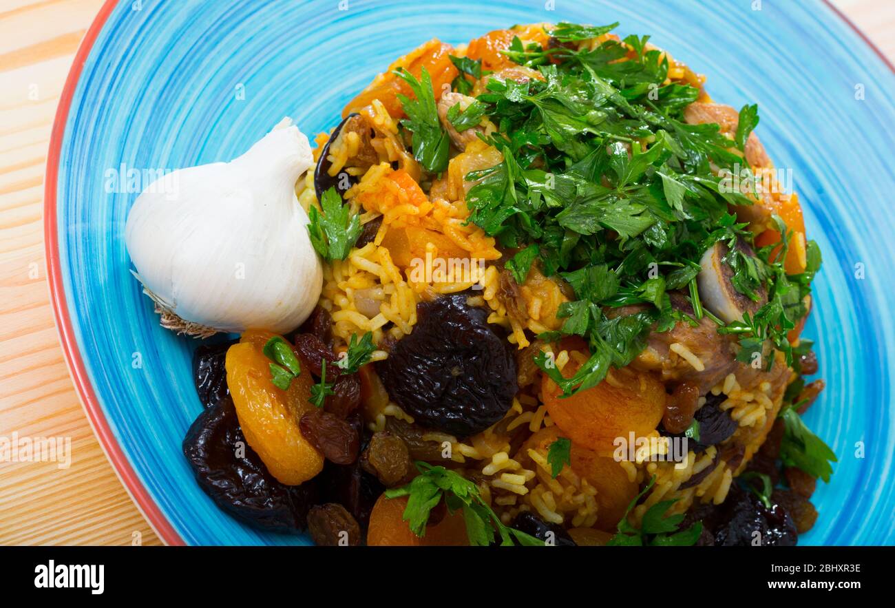 Tasty piquant pilaf from lamb, prunes, dried apricots, raisins with ...