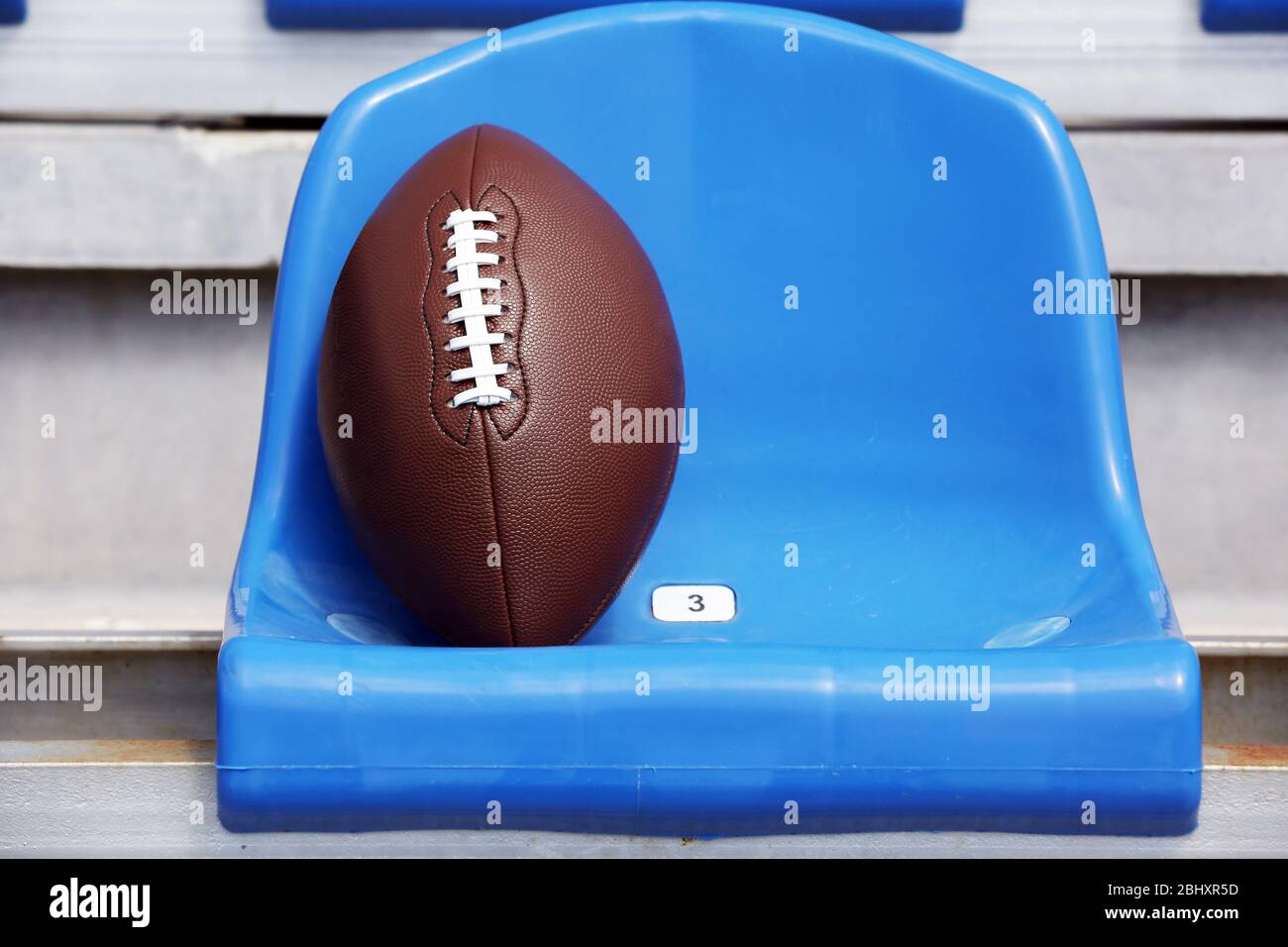 Rugby ball on stadium seat Stock Photo - Alamy