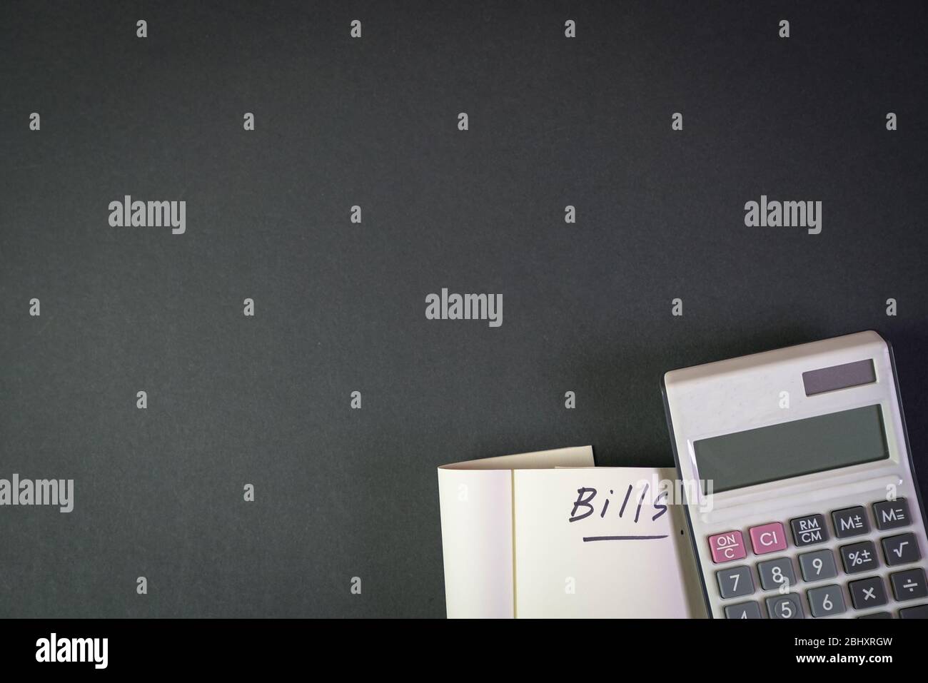 Bills. Notepad with calculator on top of black color table. Copy space ...
