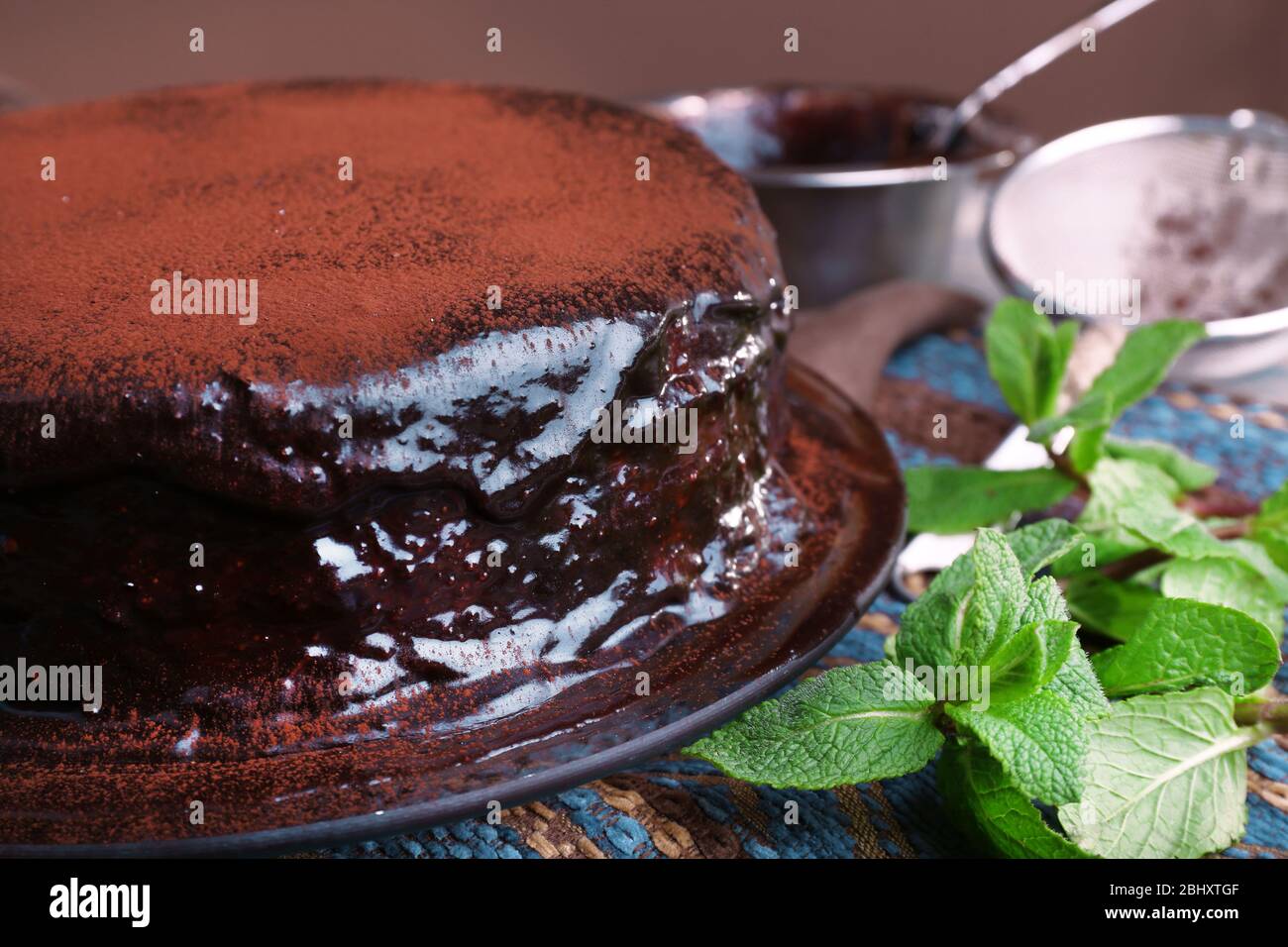 Delicious chocolate cake with icing in plate on table, closeup Stock ...