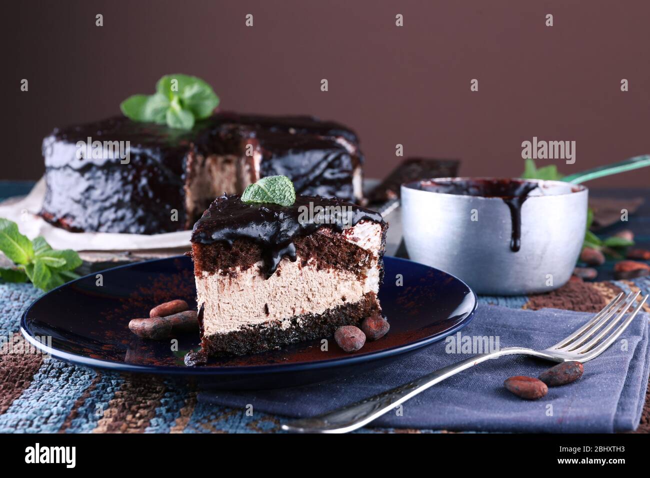 Delicious chocolate cake with icing in plate on table, closeup Stock ...