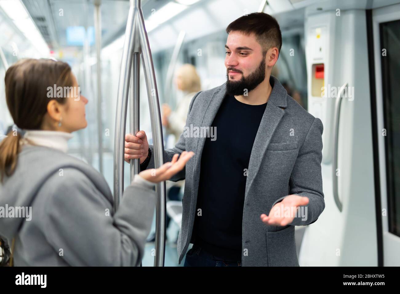 Portrait of playful positive people making acquaintance in public ...