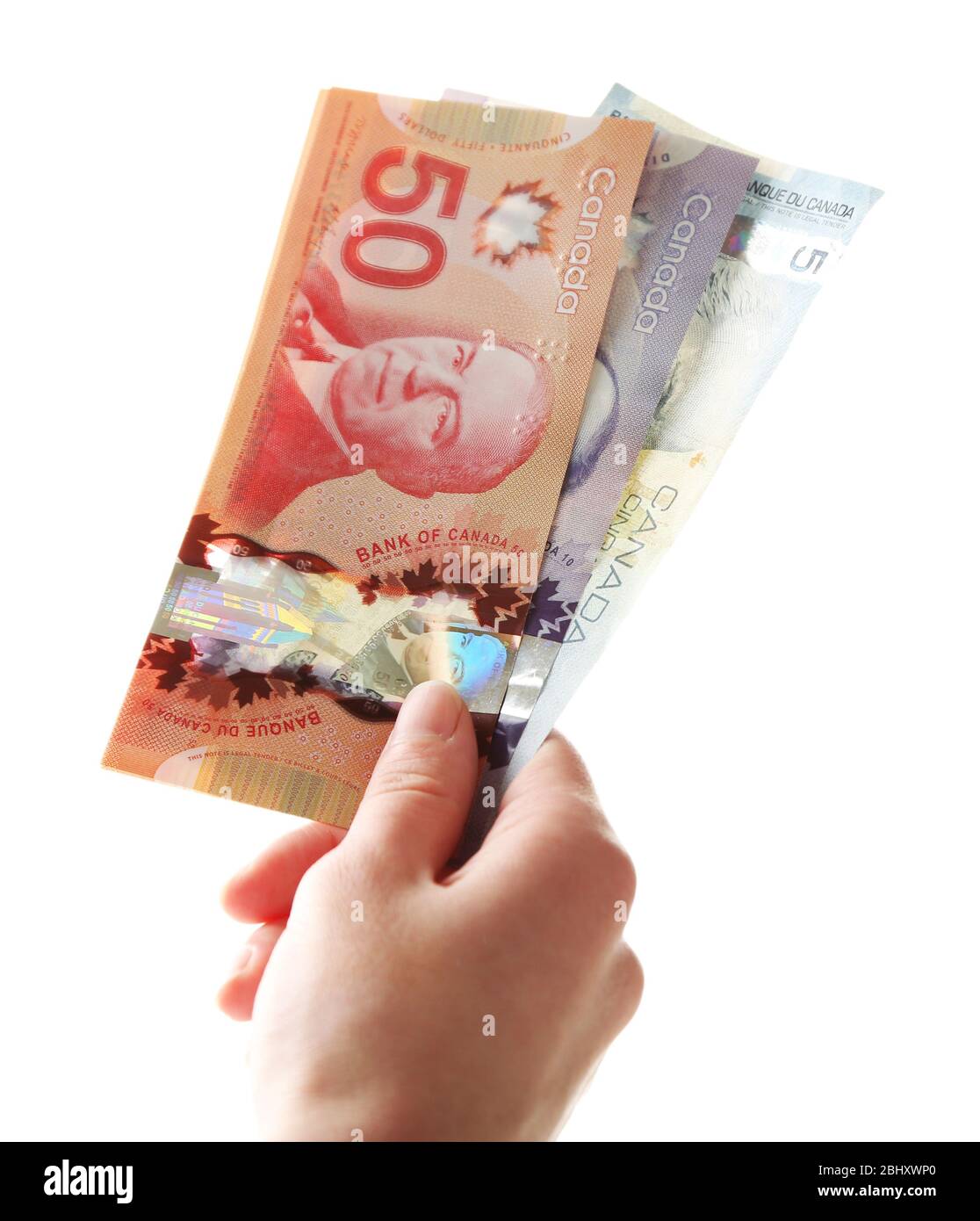 Female hand with Canadian dollars , isolated on white Stock Photo - Alamy