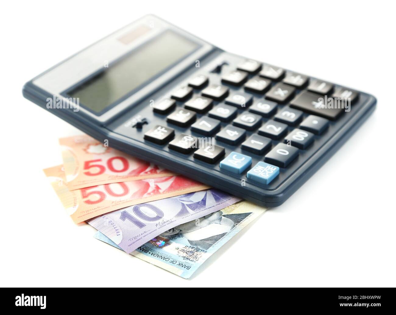 Calculator and Canadian dollars, isolated on white Stock Photo - Alamy