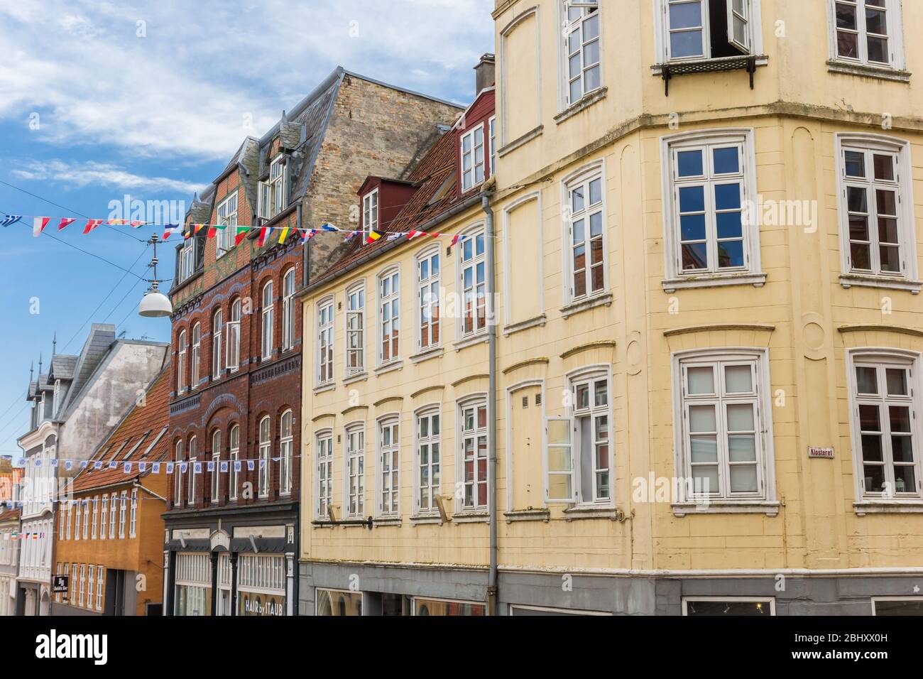 Old buildings and flags in the historic center of Haderslev, Denmark ...