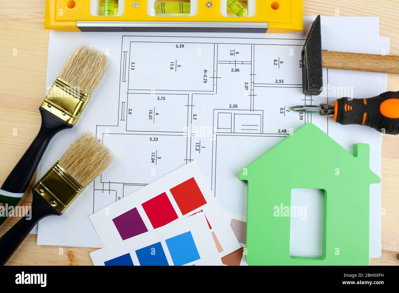 Construction instruments, plan and brushes on house plan background ...