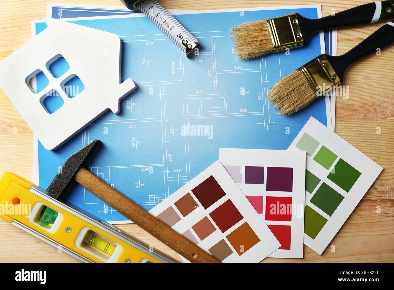 Construction instruments, plan, color samples and brushes on wooden ...