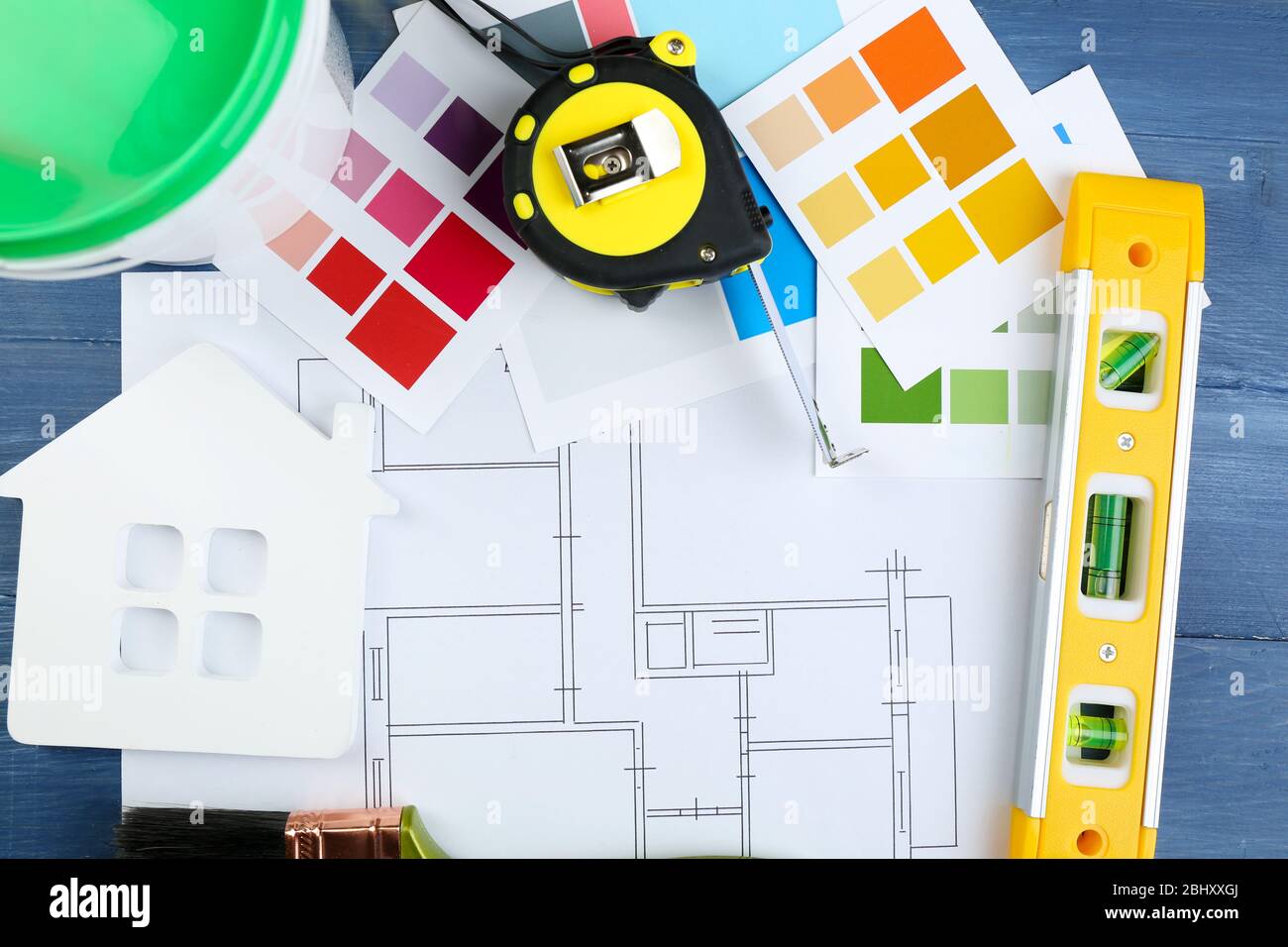 Construction instruments, plan, color samples and brushes on wooden ...