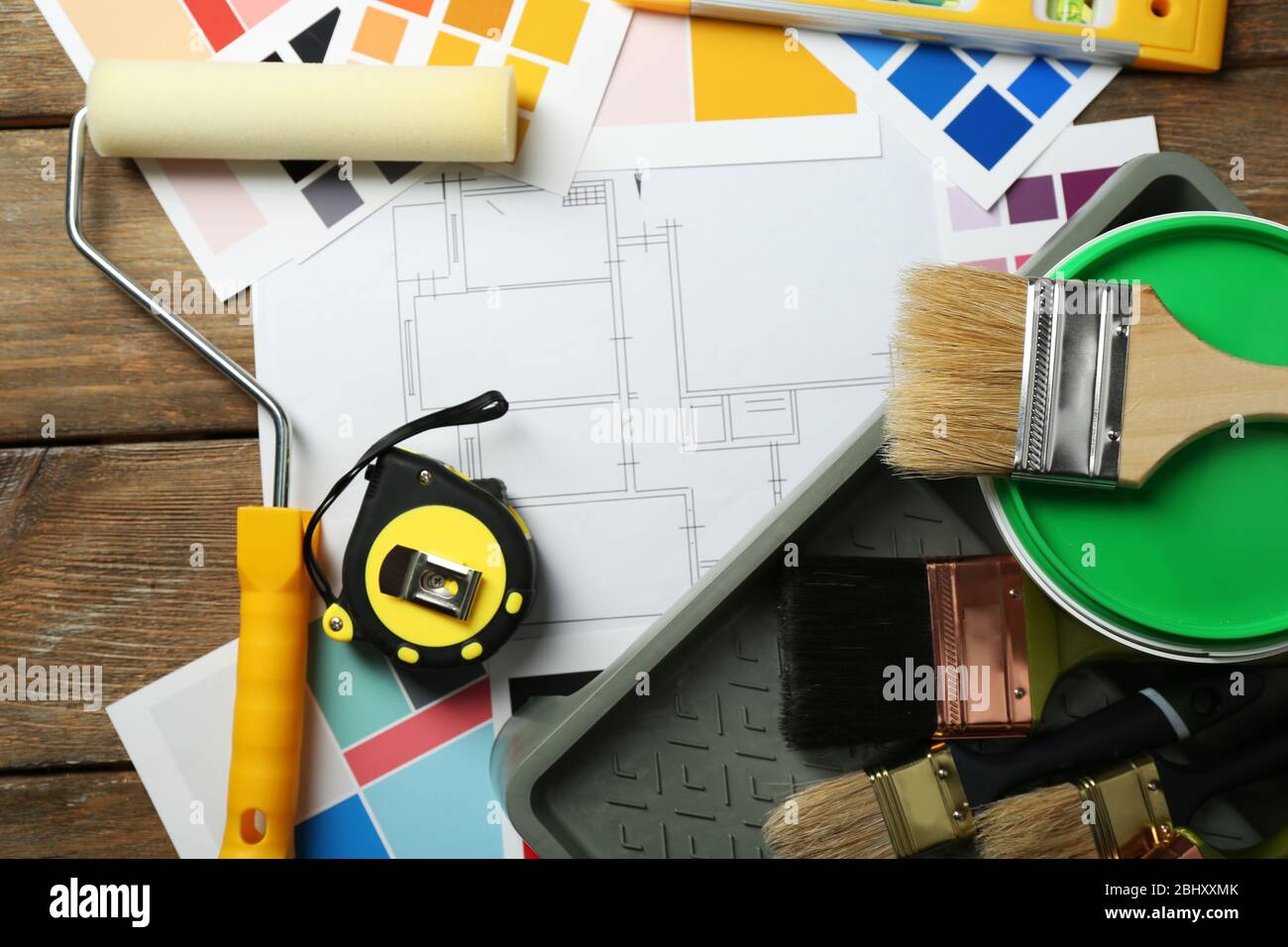 Construction instruments, plan, colorful paint samples and brushes on ...